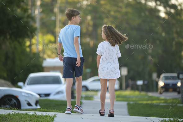 Rear view of two young teenage children, girl and boy Stock Photo by ...