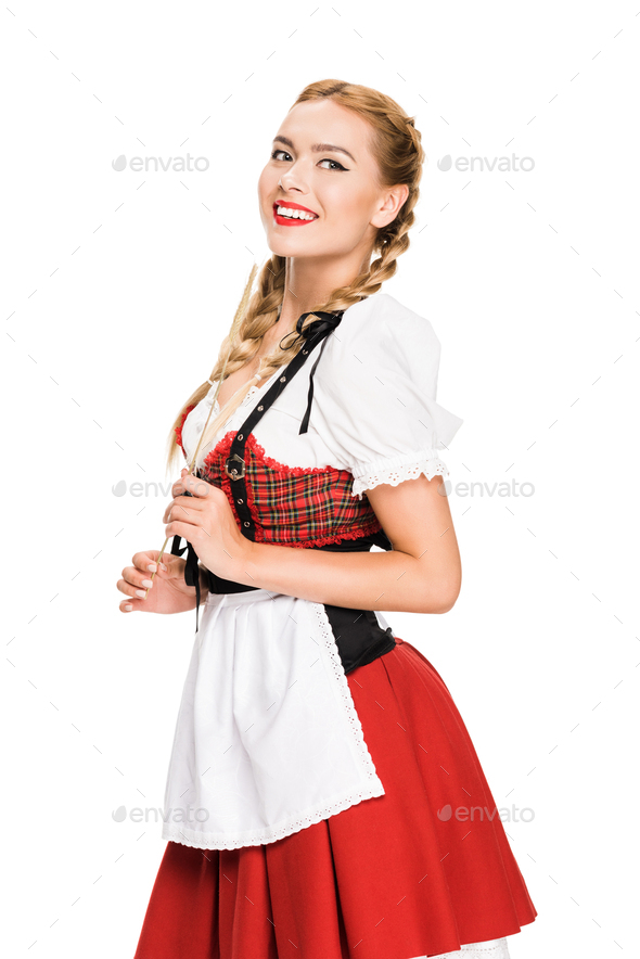 smiling girl in traditional german outfit with wheat ear, isolated on ...