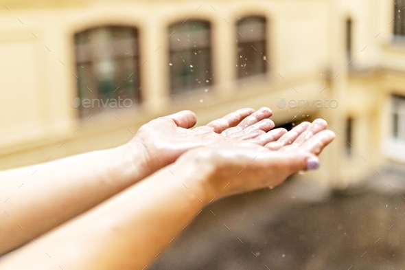 Women's hands in the rain, raindrops fall into their hands, catch Stock ...