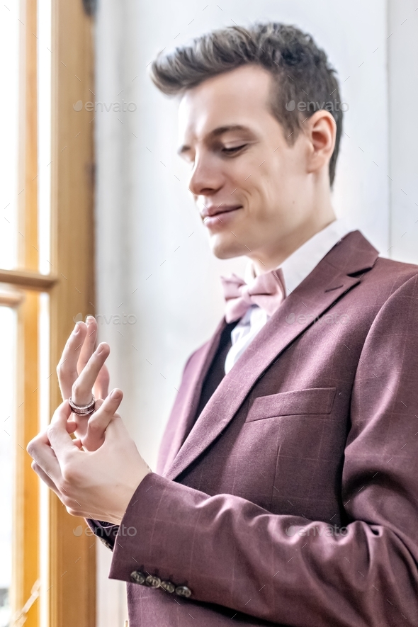 A young man groom at the door after the registration of the wedding ...