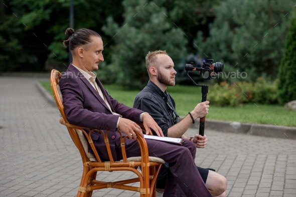 male interviewer correspondent is interviewing and filming Stock Photo ...