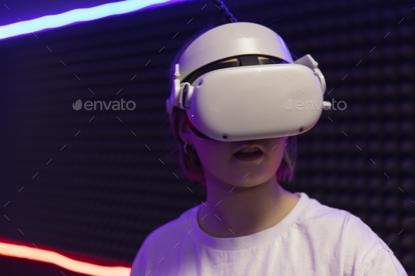 Young girl kid child playing VR game in glasses. Cyber space and ...