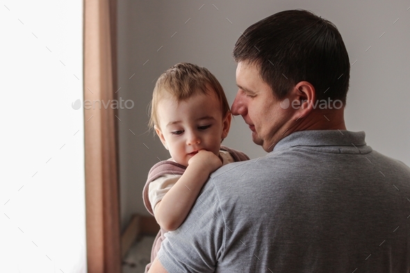 Dad hugs the child with tenderness and love Stock Photo by ElenNika