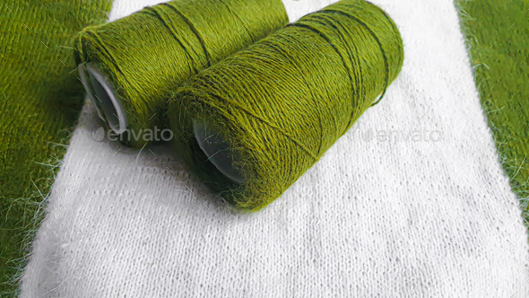 Handmade sweater. Knitted fabric from mink thread. White and olive ...