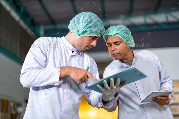 Warehouse quality control team looking checklist drinking bottle stack ...