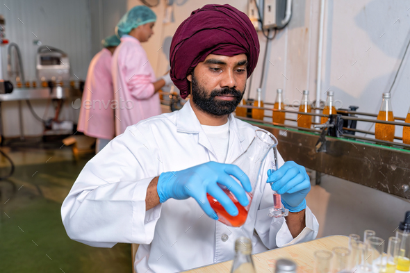 Beverage laboratory room worker in drink factory take product sample to ...