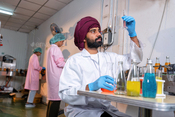 Beverage laboratory room worker in drink factory take product sample to ...