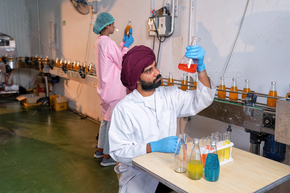 Beverage laboratory room worker in drink factory take product sample to ...