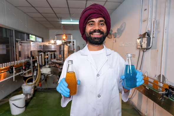 Beverage laboratory room worker in drink factory stand hold product ...