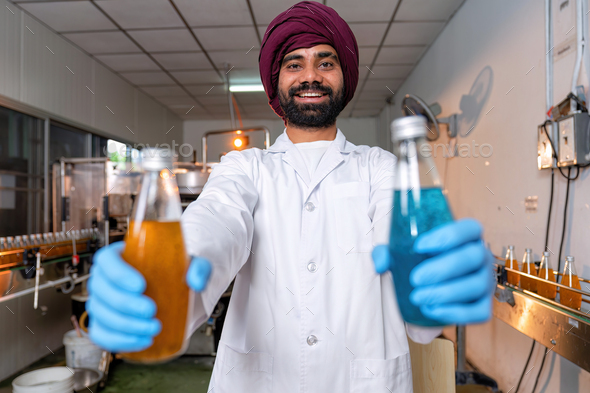 Beverage laboratory room worker in drink factory stand hold product ...