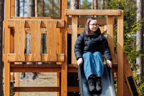 Pretty girl in creative handmade treehouse in backyard, spring activity ...