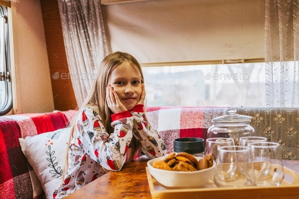 children girl sit in kitchen of trailer mobile home or recreational ...