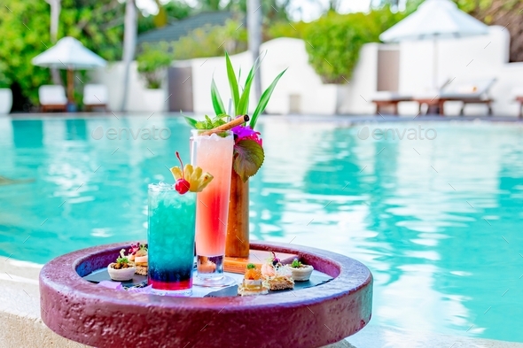 served floating tray in swimming pool with drinks and snacks on ...