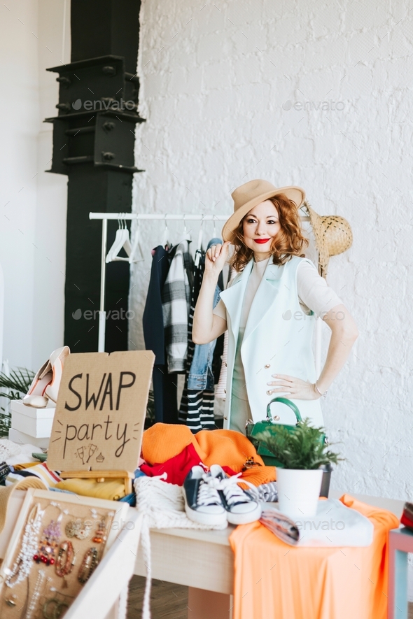 young woman female woman at swap party try on clothes, bags, shoes and ...