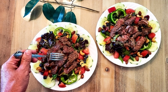 Overhead food shot of healthy salad topped with a lean steak for lunch ...