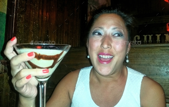 Generation X confident woman drinks a chocolate martini at happy hour ...