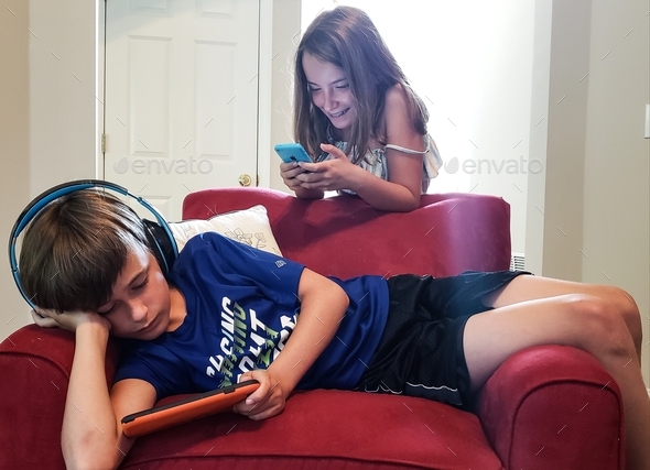 Kids using technology in their living room instead of doing their ...