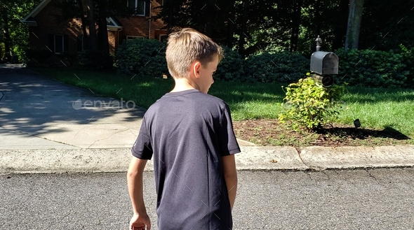 Kid in exercise mode racing down the street on his new skateboard ...