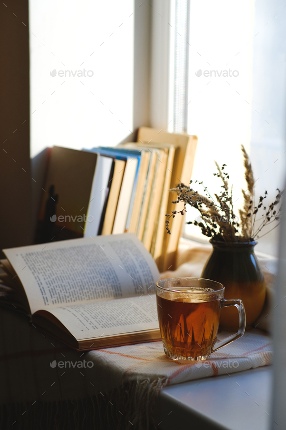 Open book, cup of tea, dry flowers in a vase on a windowsill. Stock ...