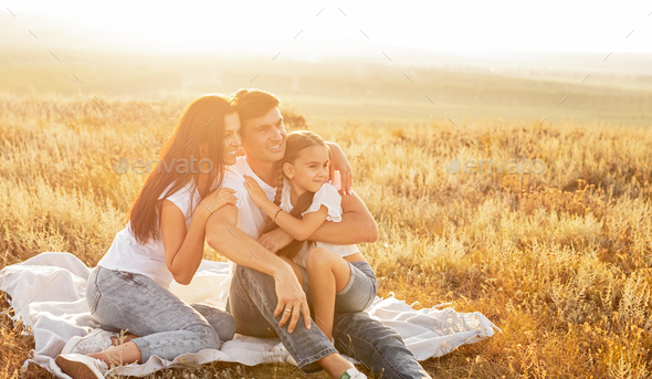Happy family hugging and resting in nature Stock Photo by kegfire ...