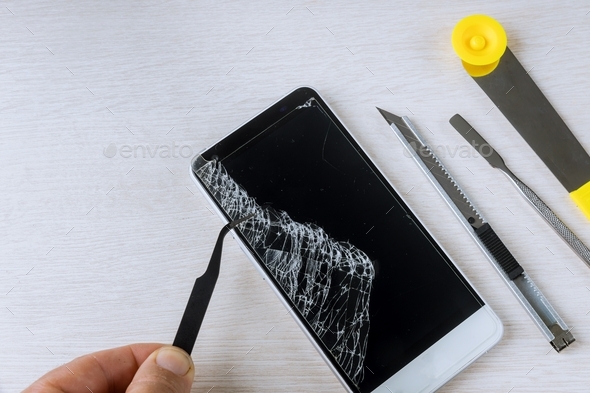 Broken phones on cracked screen details of the cell phone repair tools ...