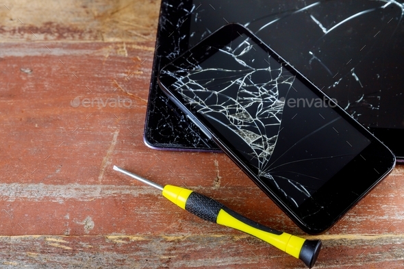 Broken smart phone and tablet on cracked touch screen process of mobile ...