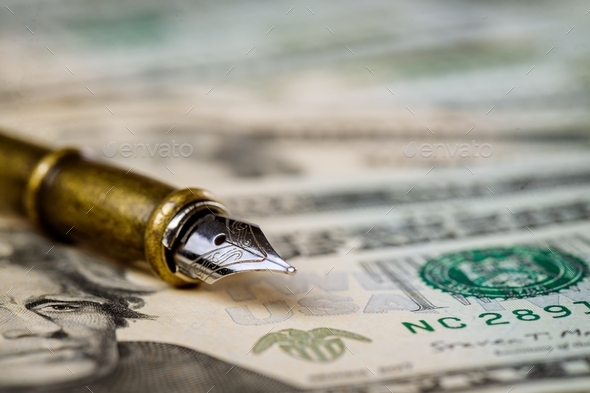 Currency US dollar banknotes close-up with ballpoint pen Stock Photo by ...
