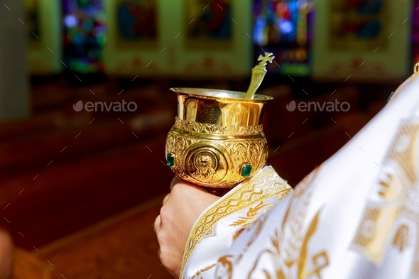catholic priest with chalice cup during consecration ceremony church ...