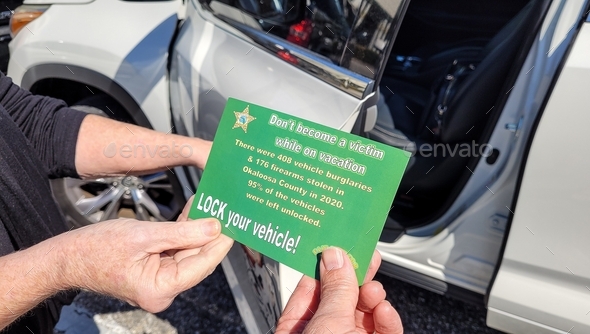 Cop giving driver a reminder to avoid being a victim of crime by ...