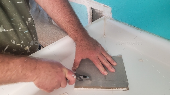 Hands of Painter cuts plaster board to fit in damaged wall in home to ...
