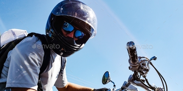 Generation z teenager with safety helmet riding motorcycle in candids ...