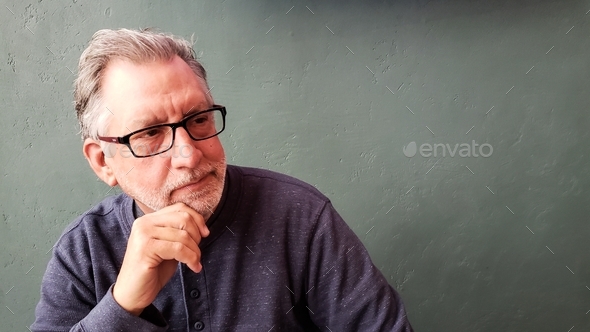 Active baby boomer in hands and face jester in restaurant at happy hour ...