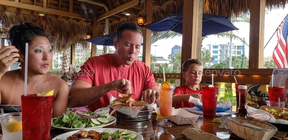 Generation x couple eating healthy in restaurant with generation z ...
