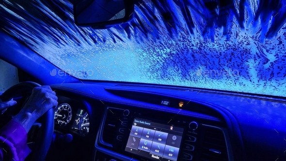 Getting car wash in the dark with abstract patterns and shapes on ...