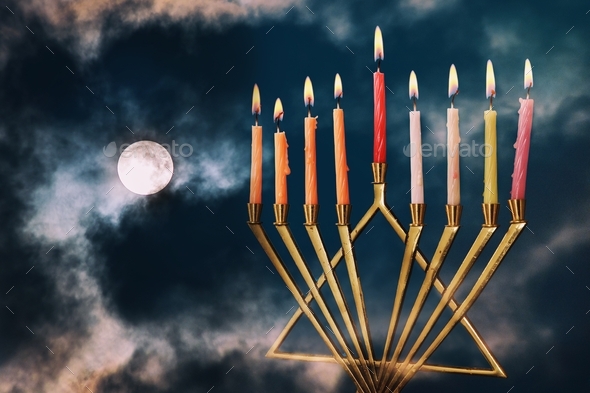 Jewish holiday Hanukkah menorah with sparks on full moon in the clouds ...