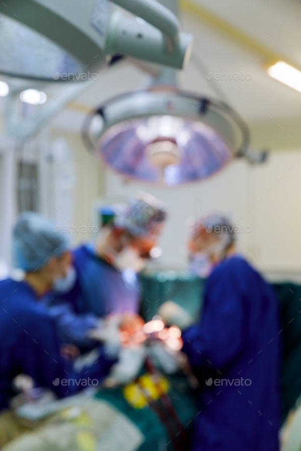 soft focus in the surgical operating room Surgeon hands the open heart ...