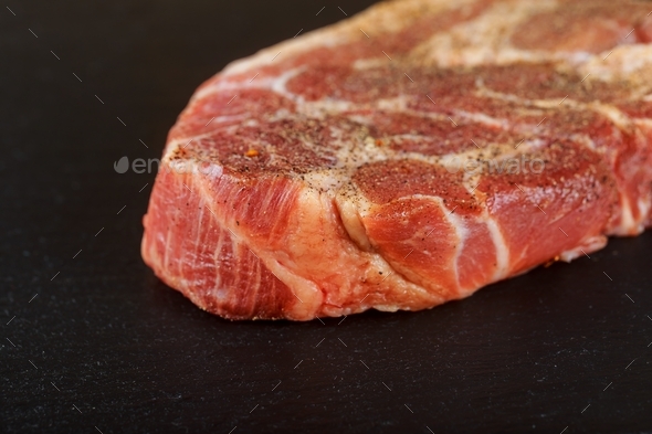 Fresh raw Prime Black Angus Rib Eye beef steak on stone background. Top ...