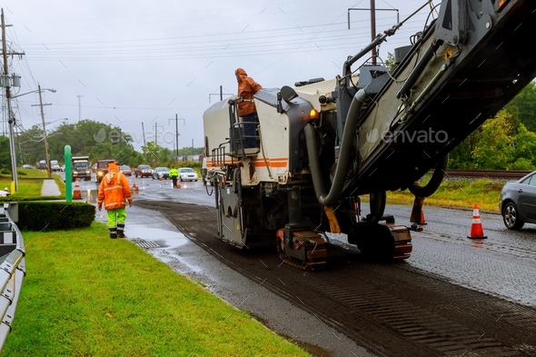 Road works asphalt removing machine loading powdered asphalt on the ...