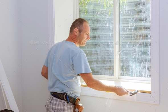 Carpenter installation of moldings trim complete window Stock Photo by ...