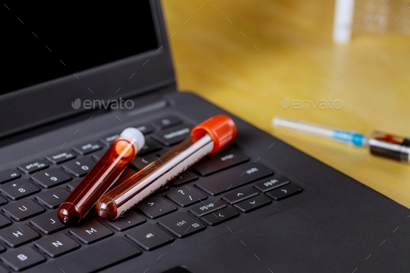 Medical in laboratory working on computer test blood tubes office of ...