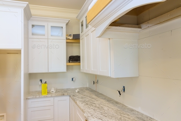 Kitchen furniture set installation in hanging cabinet Stock Photo by ...