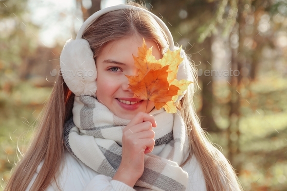Cute teenage girl in fall park with autumn leaves Stock Photo by AlexVog
