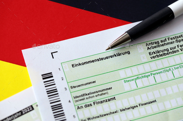 German annual income tax return declaration form with pen on flag close ...