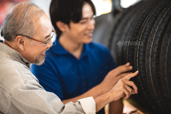 Young Asian male garage owner, salesman and representative in ...