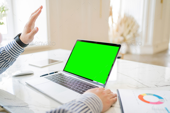 Workplace laptop open green screen. Video call online communication ...