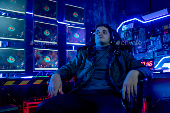 Caucasian gamer man sit with relax on chair and look forward with ...