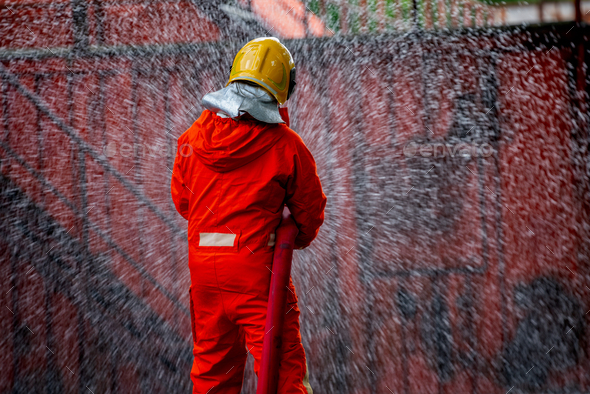 Firefighter practice to use sprinkler to splash as circular and ...