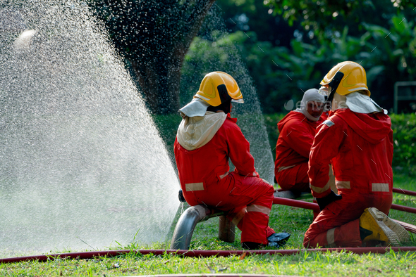 Group of firefighter sit and relax after success to extinguish fire ...