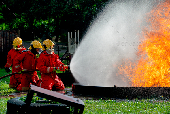 Side view of firefighters support to use sprinkler to create water ...