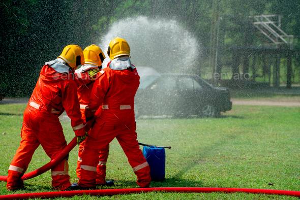 Firefighters help and support to use fire sprinkler to spray water to ...